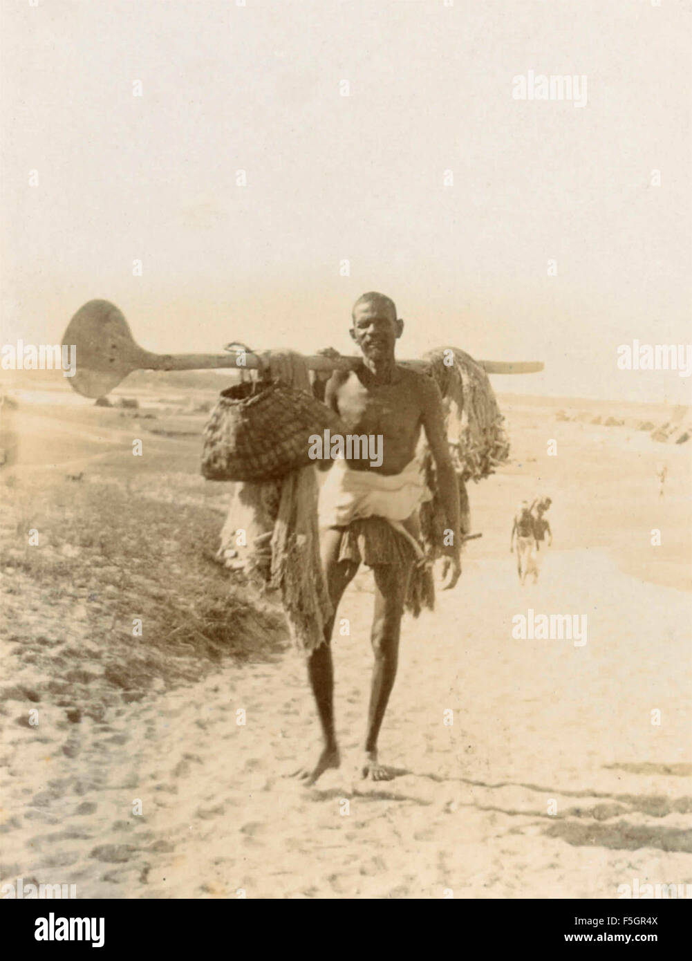 A man walks with a pole rocker , India Stock Photo - Alamy