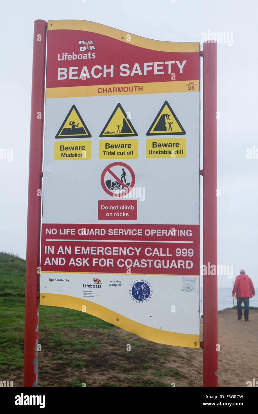 Sign rock fall danger.Hunting for fossils on a wind-swept and wet day ...