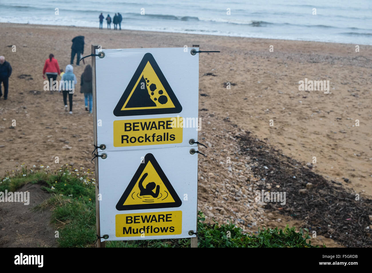 Sign rock fall danger.Hunting for fossils on a wind-swept and wet day ...