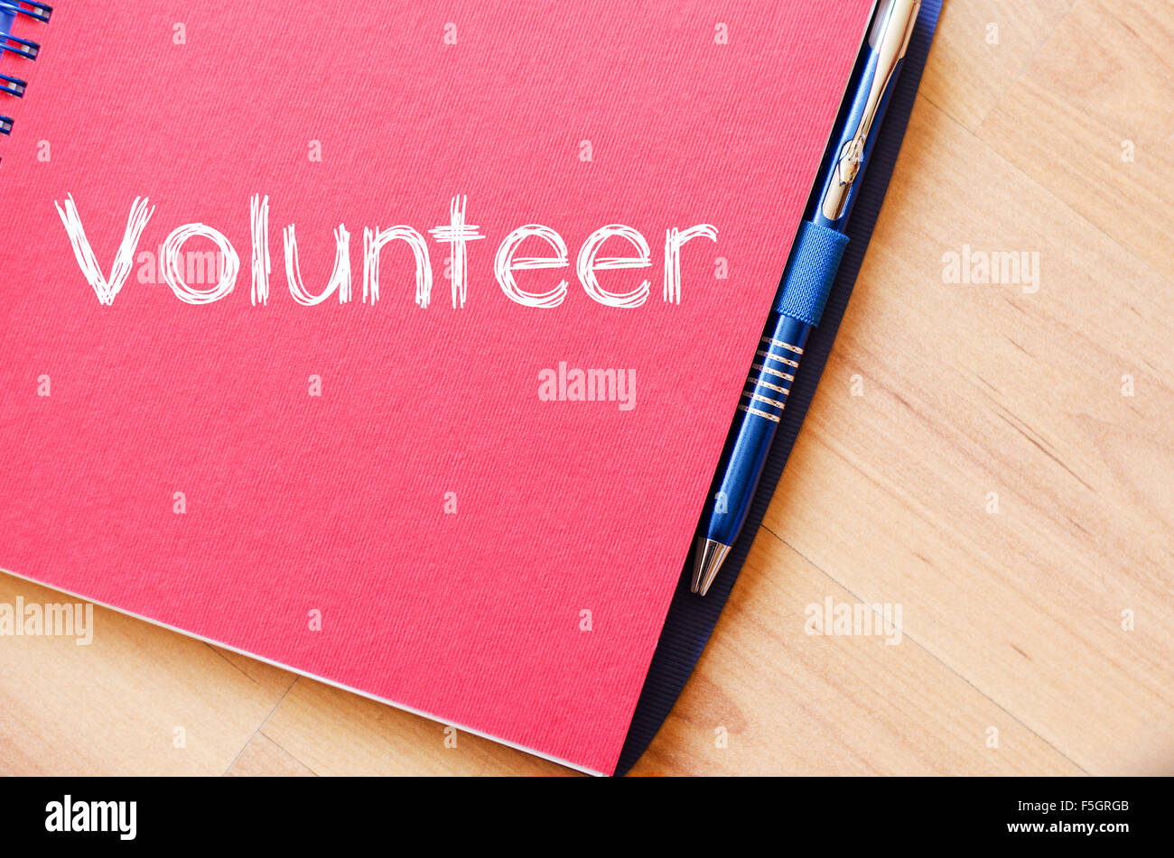 Volunteer text concept write on notebook Stock Photo - Alamy