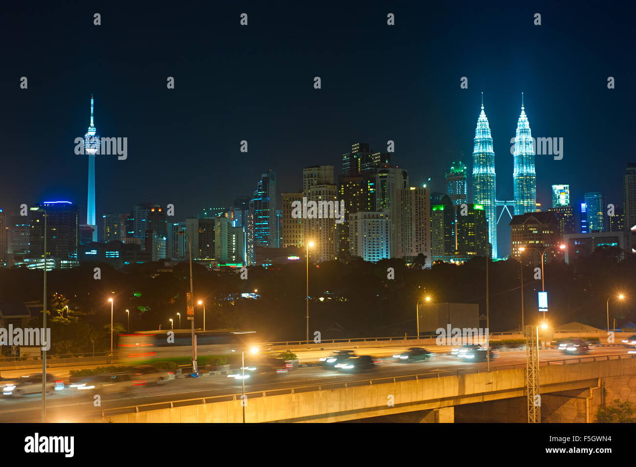 NIght traffic in Kuala Lumpur. Skyline of KL on the background ...