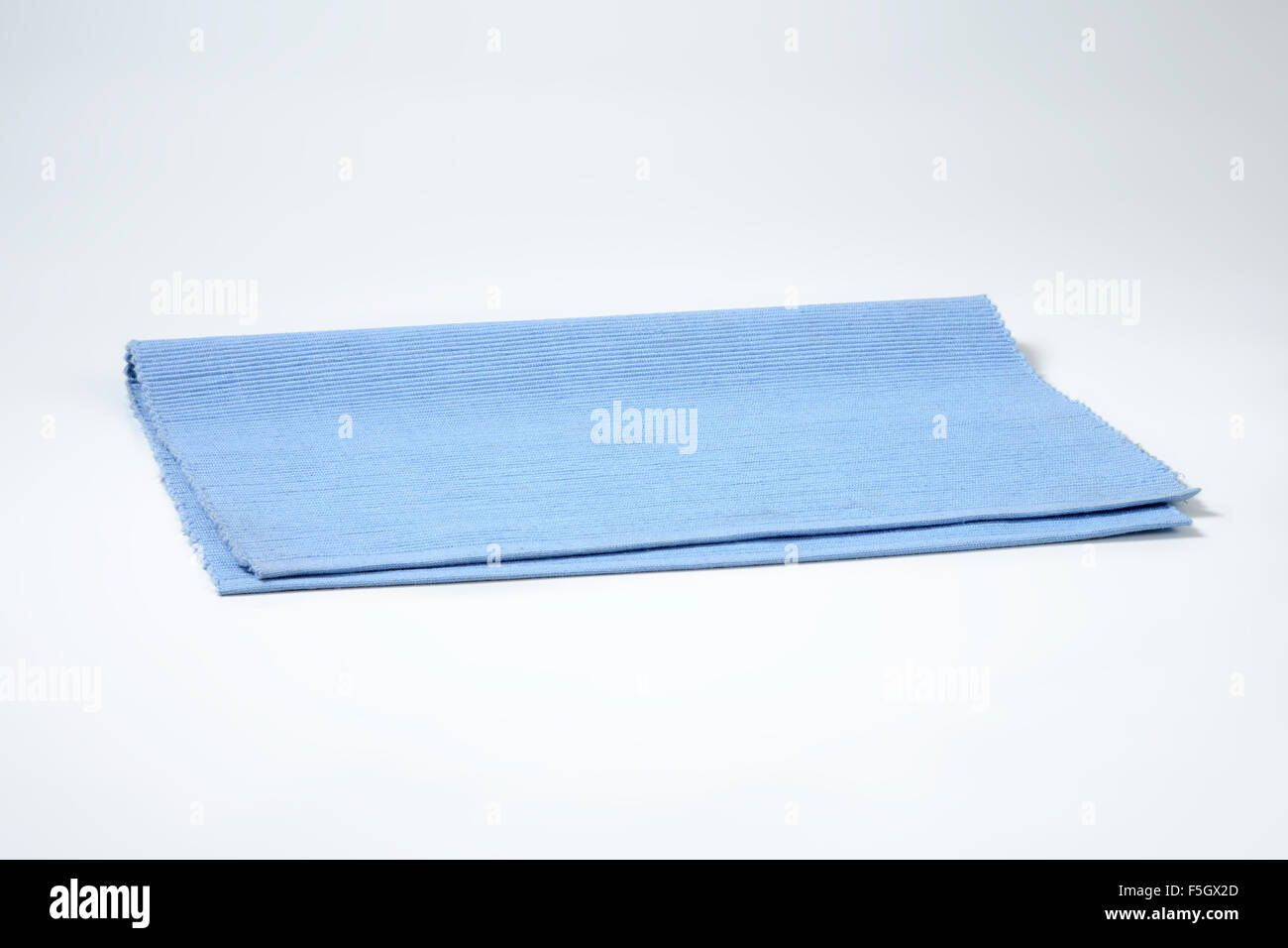 blue place mat on white background Stock Photo - Alamy