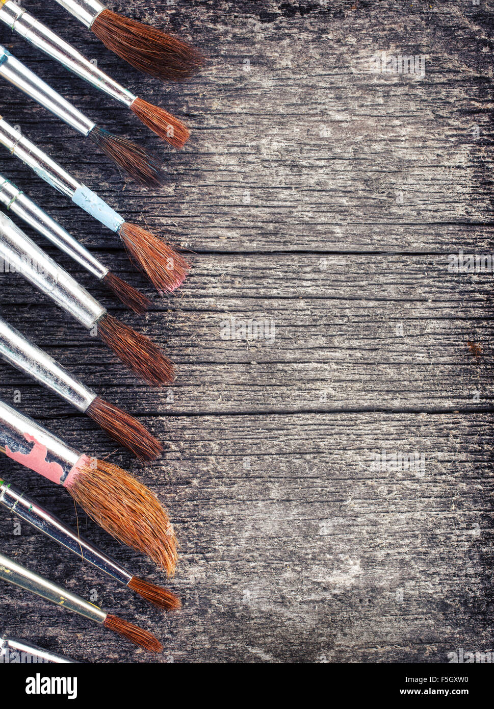 brushes for painting on wooden background Stock Photo - Alamy
