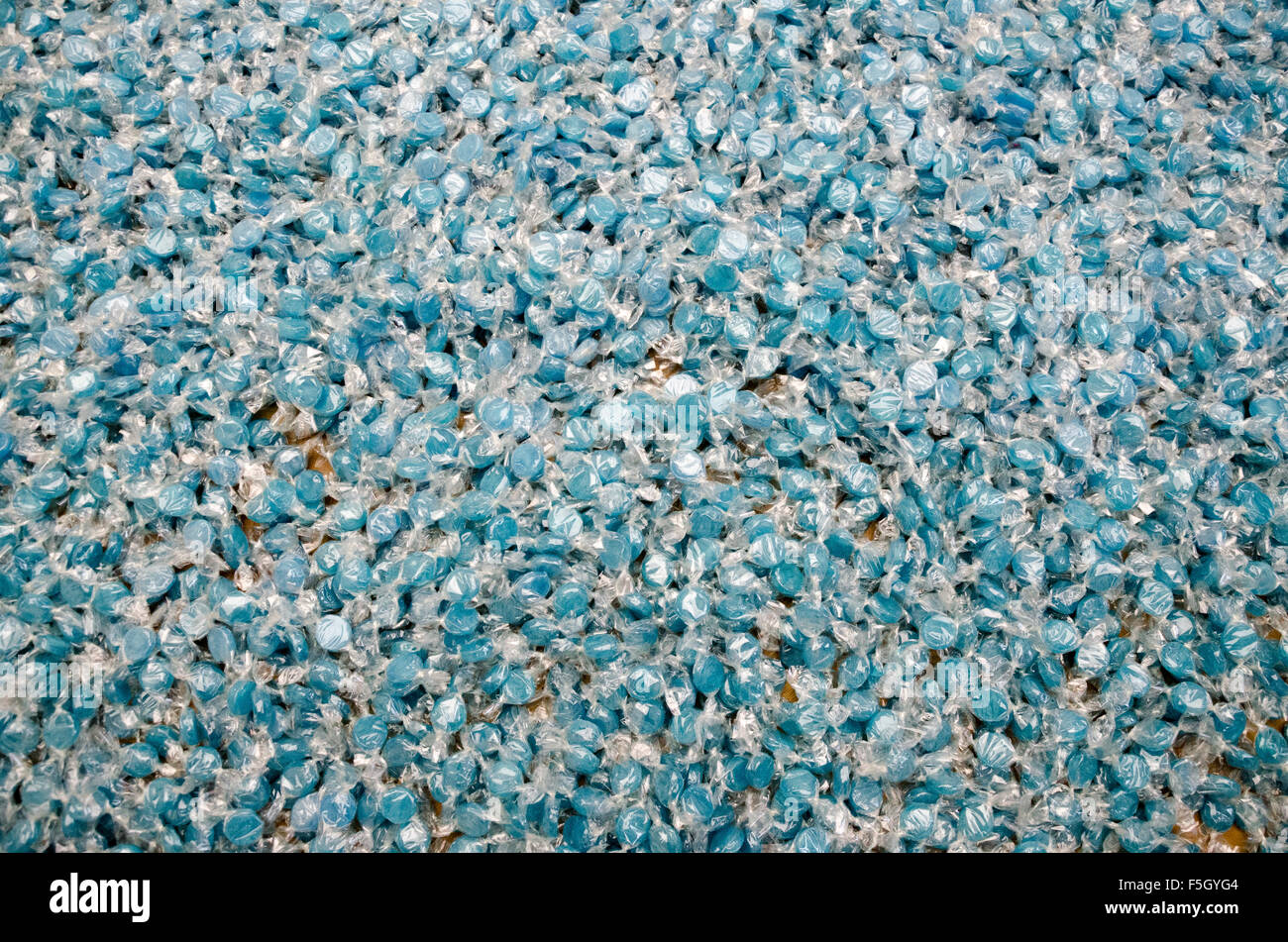 Mountain of packed blue candies Stock Photo - Alamy