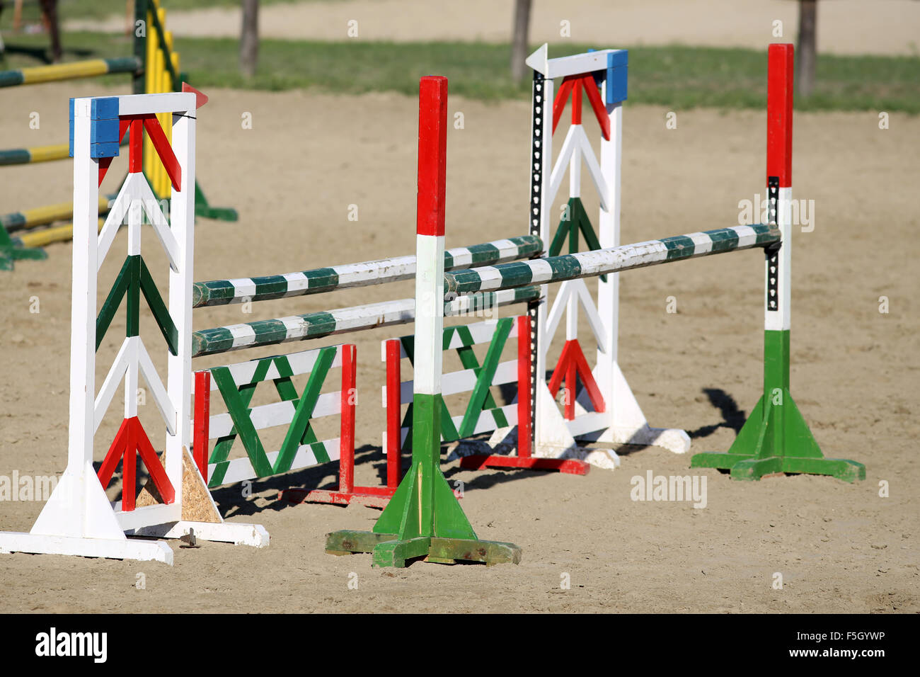 Colorful oxer on the ground for jumping horses as a background Stock ...