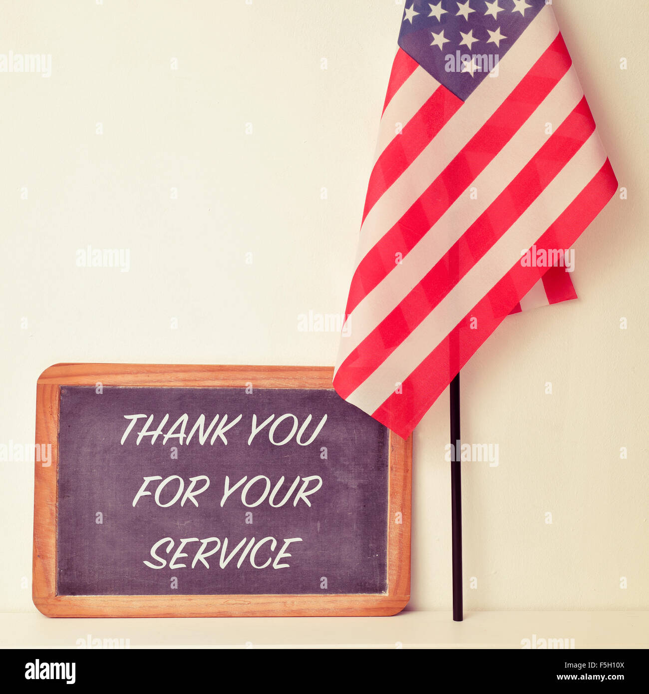 the text thank you for your service written in a chalkboard and a flag ...