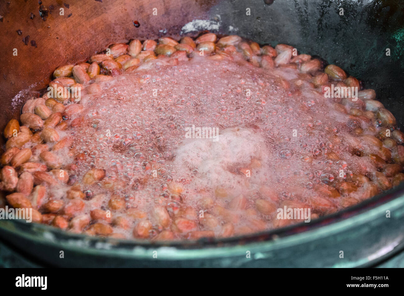 Praline peanuts boiling in the caramel toffee Stock Photo - Alamy