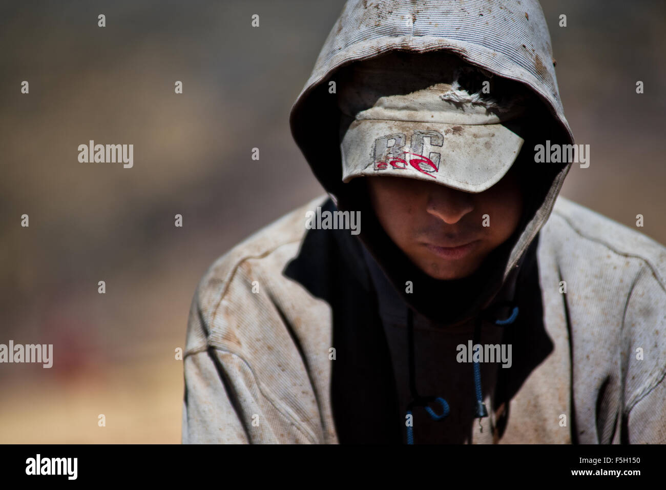A Peruvian boy chews coca leaves while working at a brick factory in ...