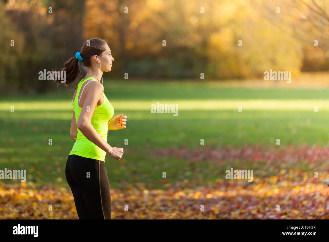 Female fitness model training outside and running Stock Photo - Alamy