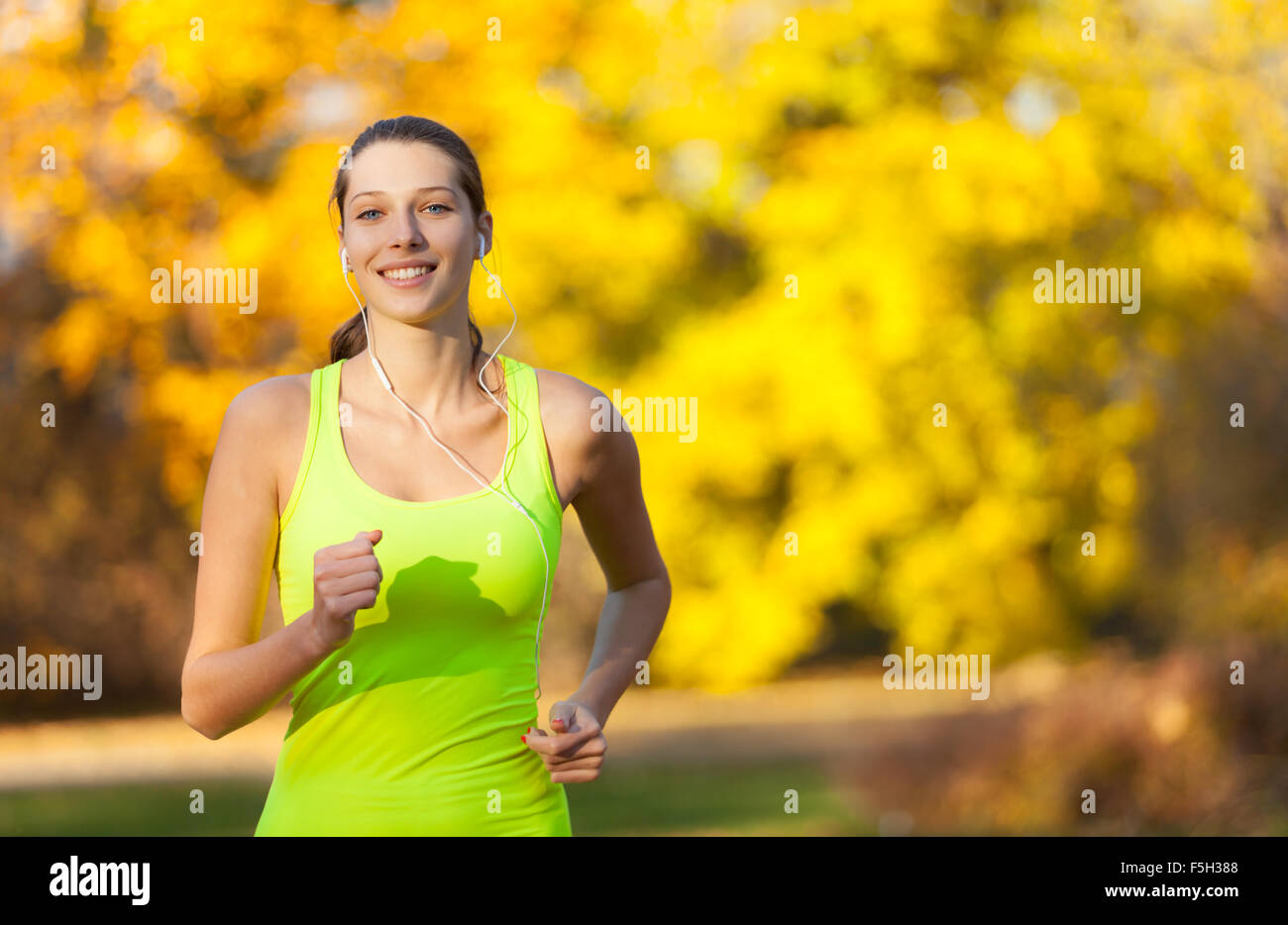 Female fitness model training outside and running Stock Photo - Alamy