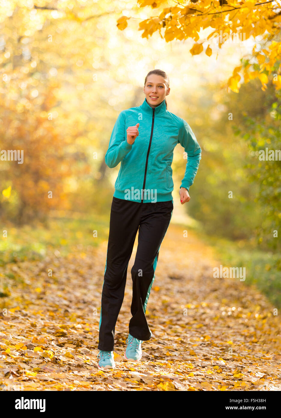 Female fitness model training outside and running Stock Photo - Alamy