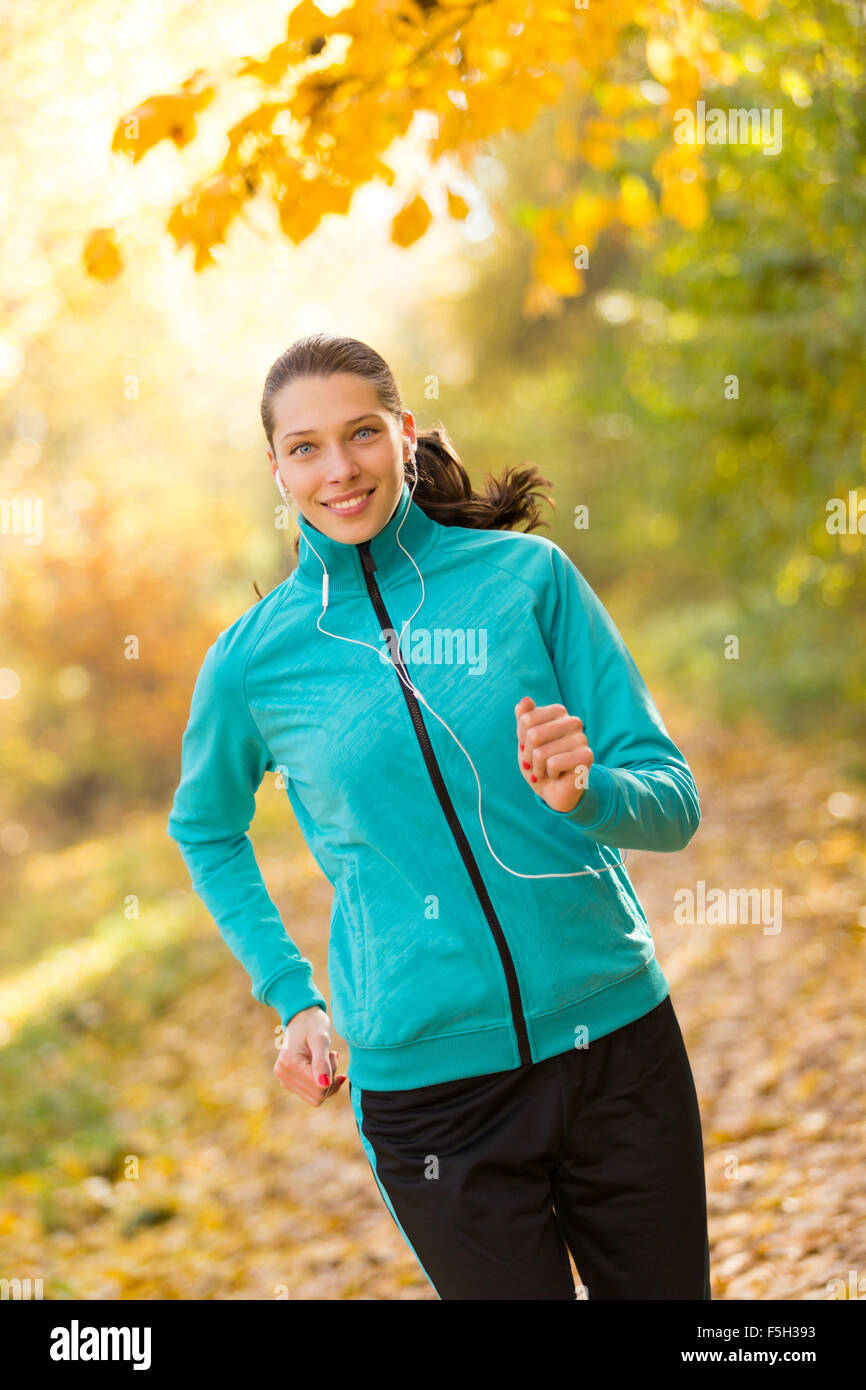 Female fitness model training outside and running Stock Photo - Alamy
