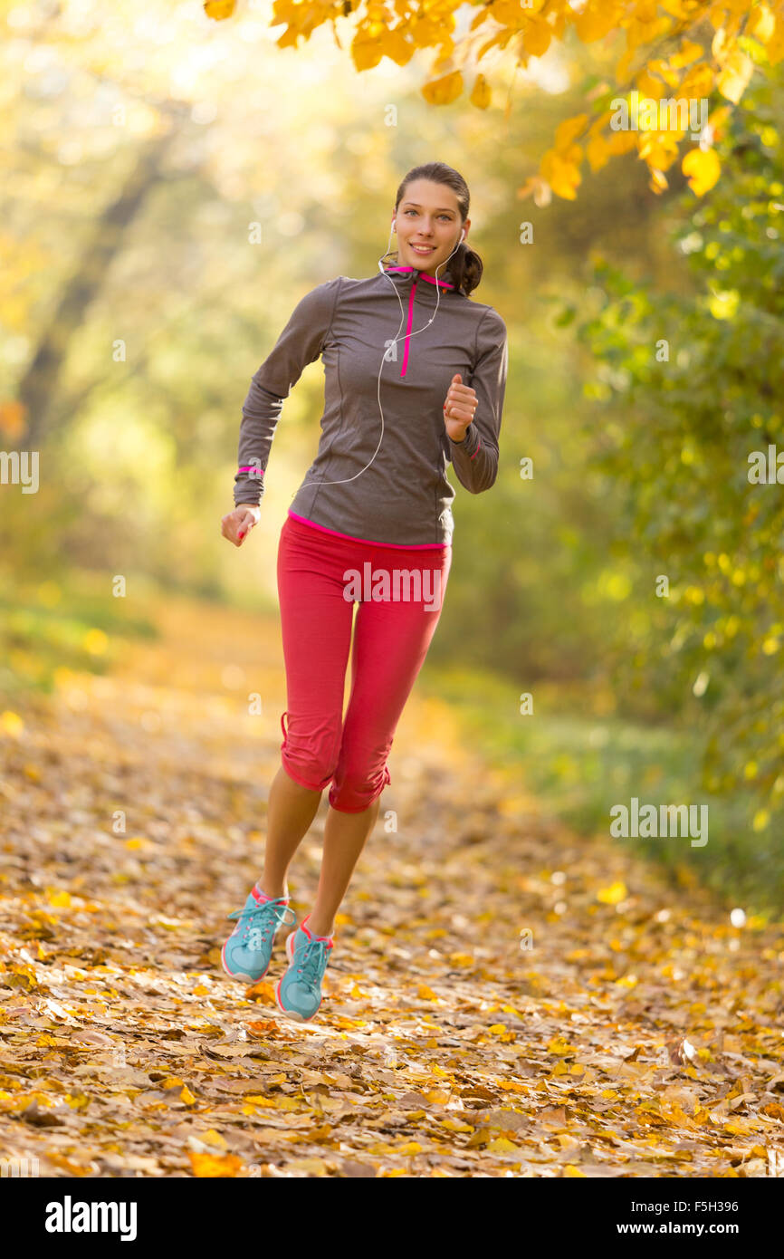 Female fitness model training outside and running Stock Photo - Alamy