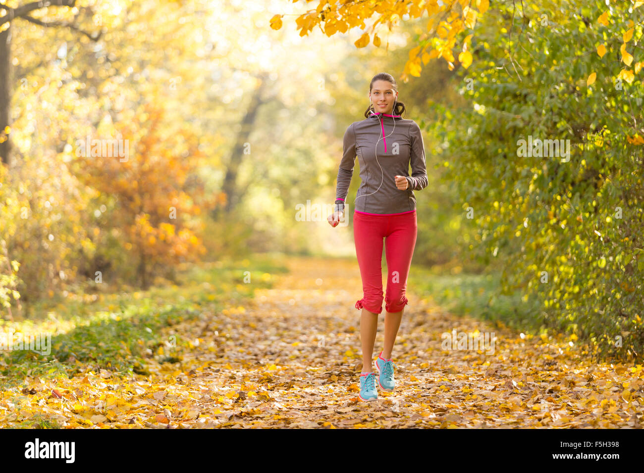 Female fitness model training outside and running Stock Photo - Alamy