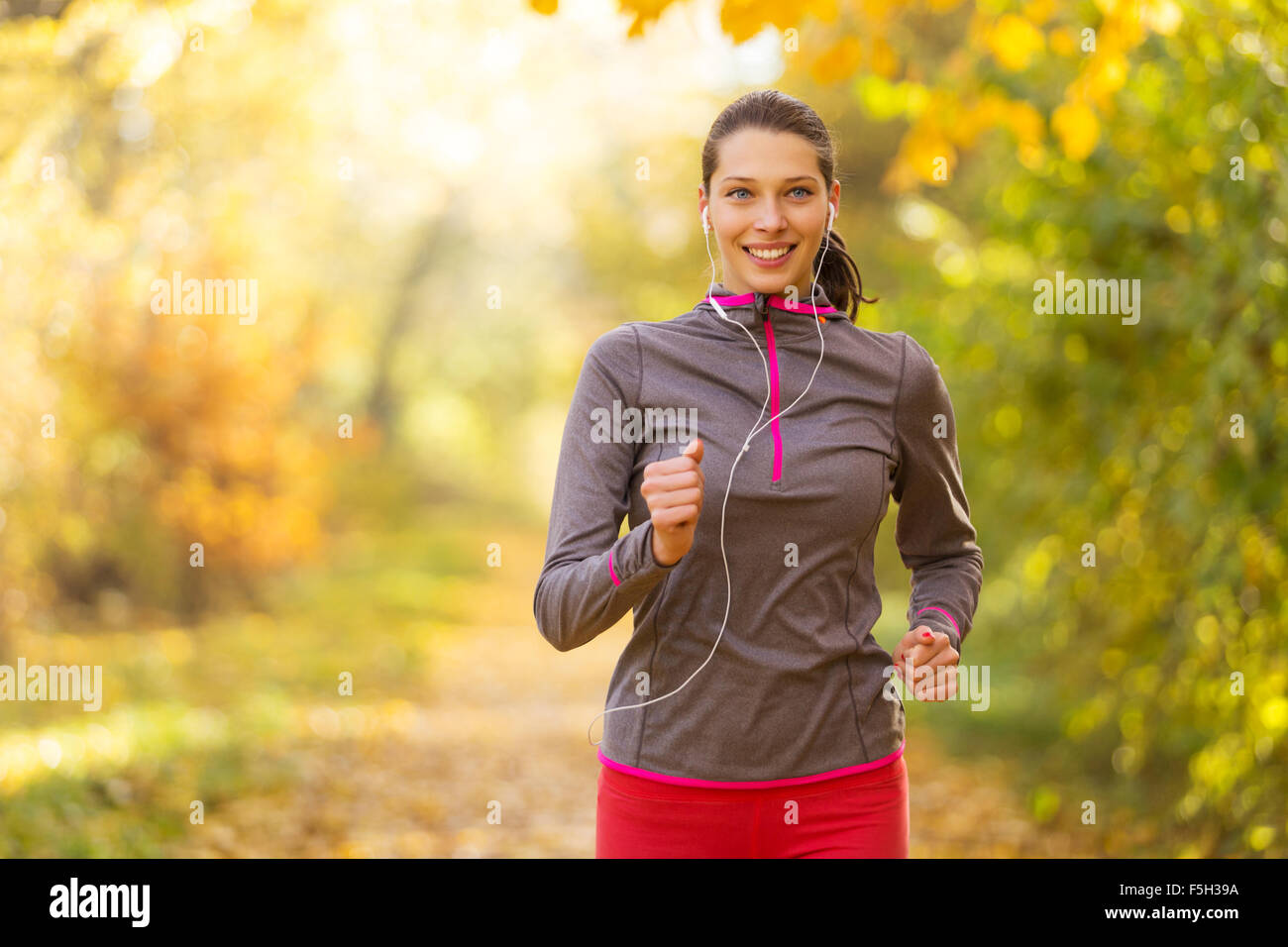 Female fitness model training outside and running Stock Photo - Alamy