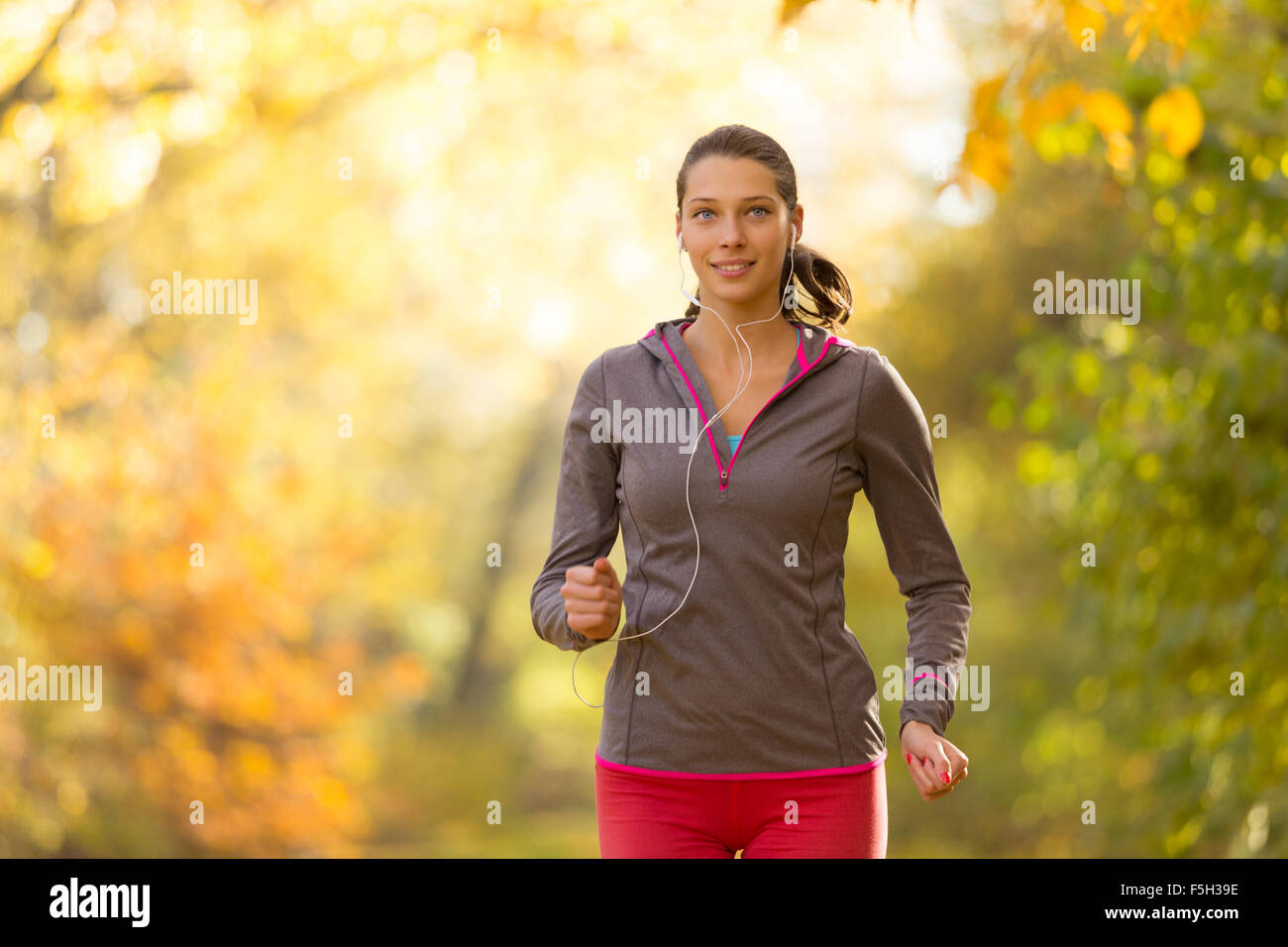 Female fitness model training outside and running Stock Photo - Alamy