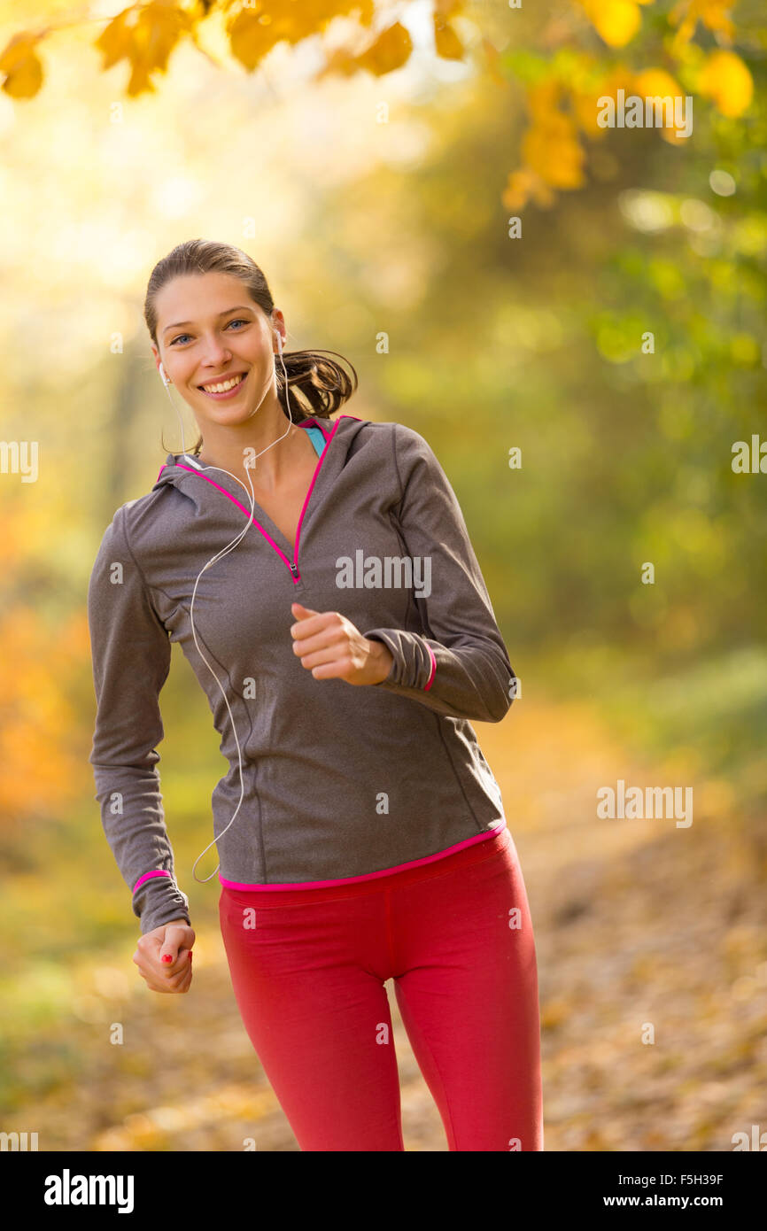 Female fitness model training outside and running Stock Photo - Alamy