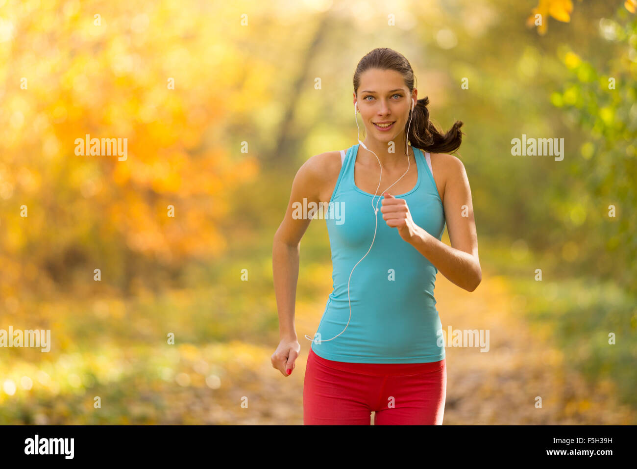Female fitness model training outside and running Stock Photo - Alamy