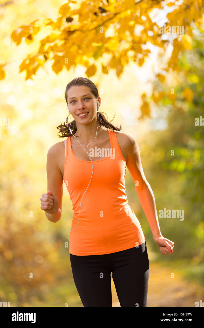Female fitness model training outside and running Stock Photo - Alamy