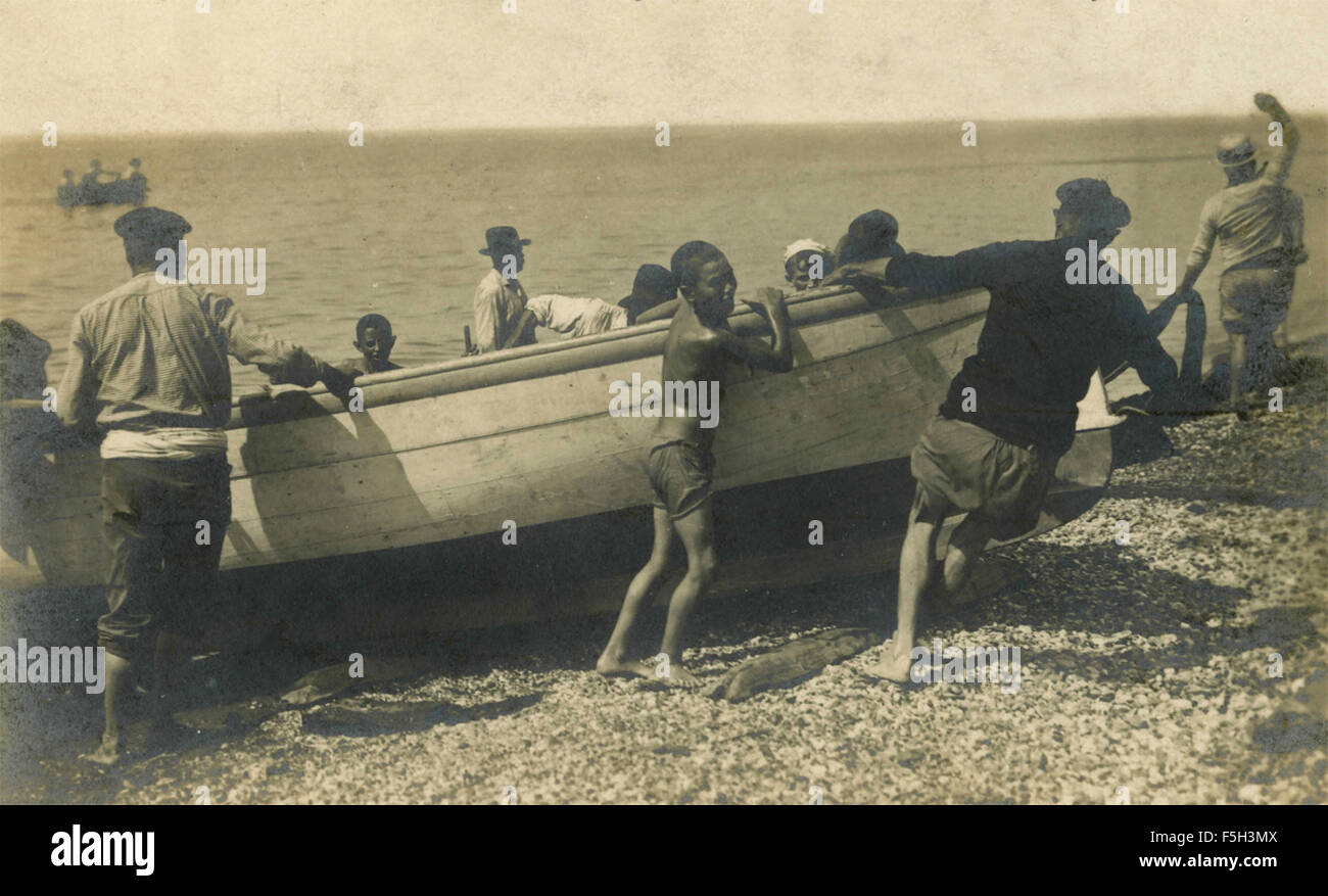Pulling the boat ashore, Italy Stock Photo - Alamy