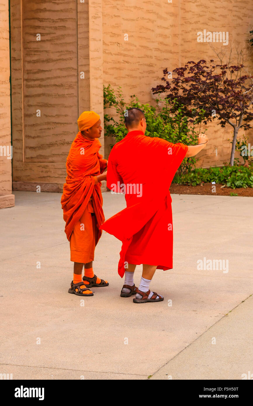 Buddist monks takes tourist photos with a digital camera at the Palace ...