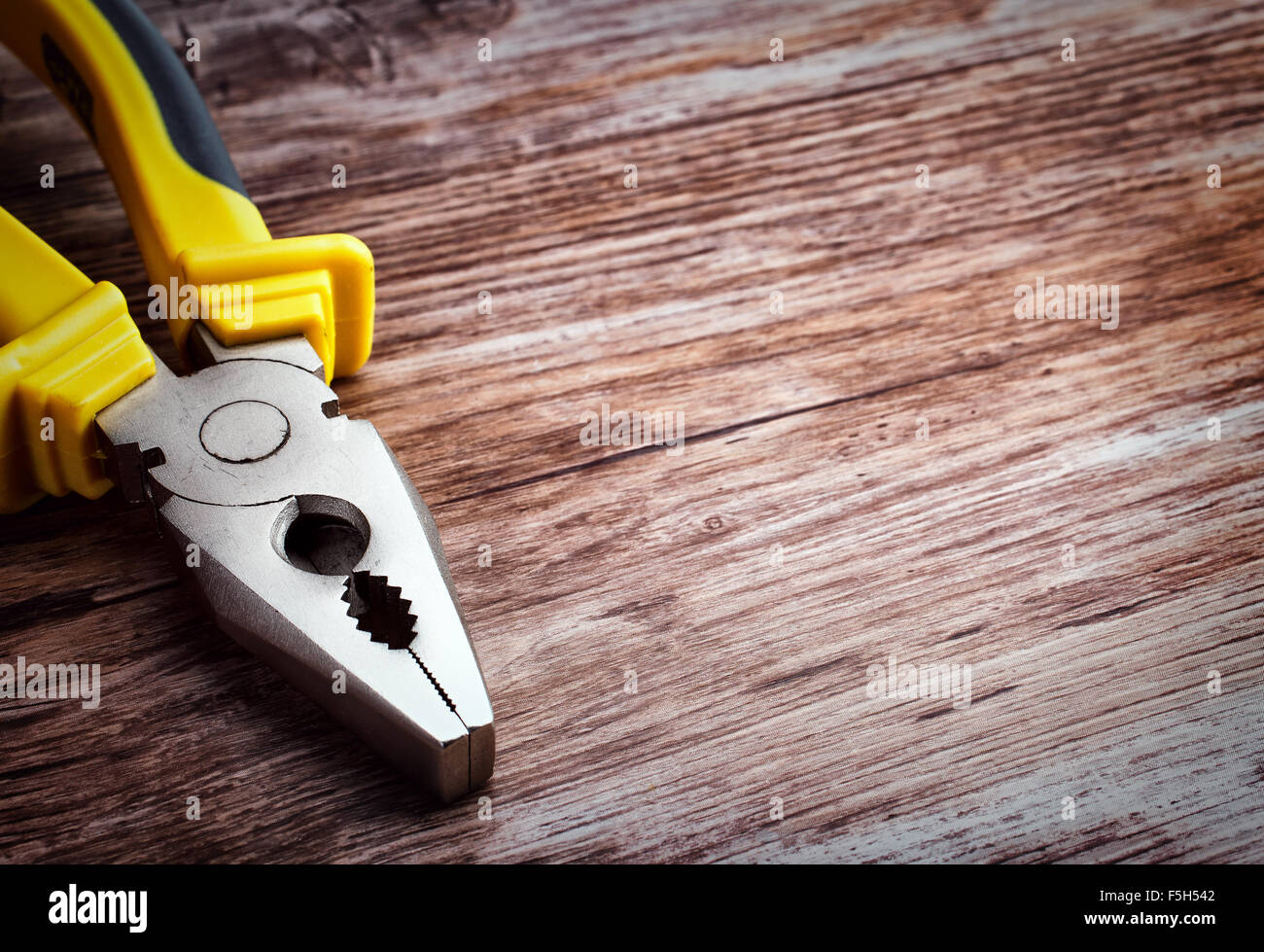 multitool pliers on wooden background Stock Photo - Alamy