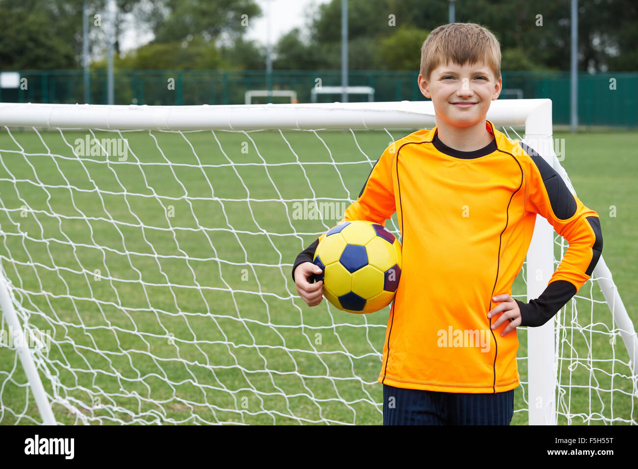 Portrait Of Goal Keeper Holding Ball On School Soccer Pitch Stock Photo ...