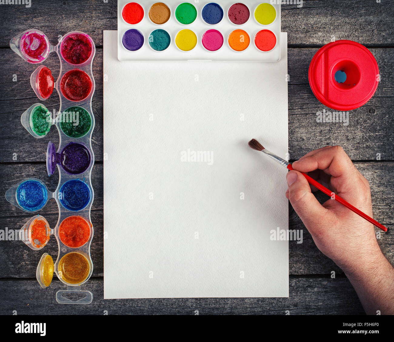 hand with brush painting with watercolor Stock Photo - Alamy