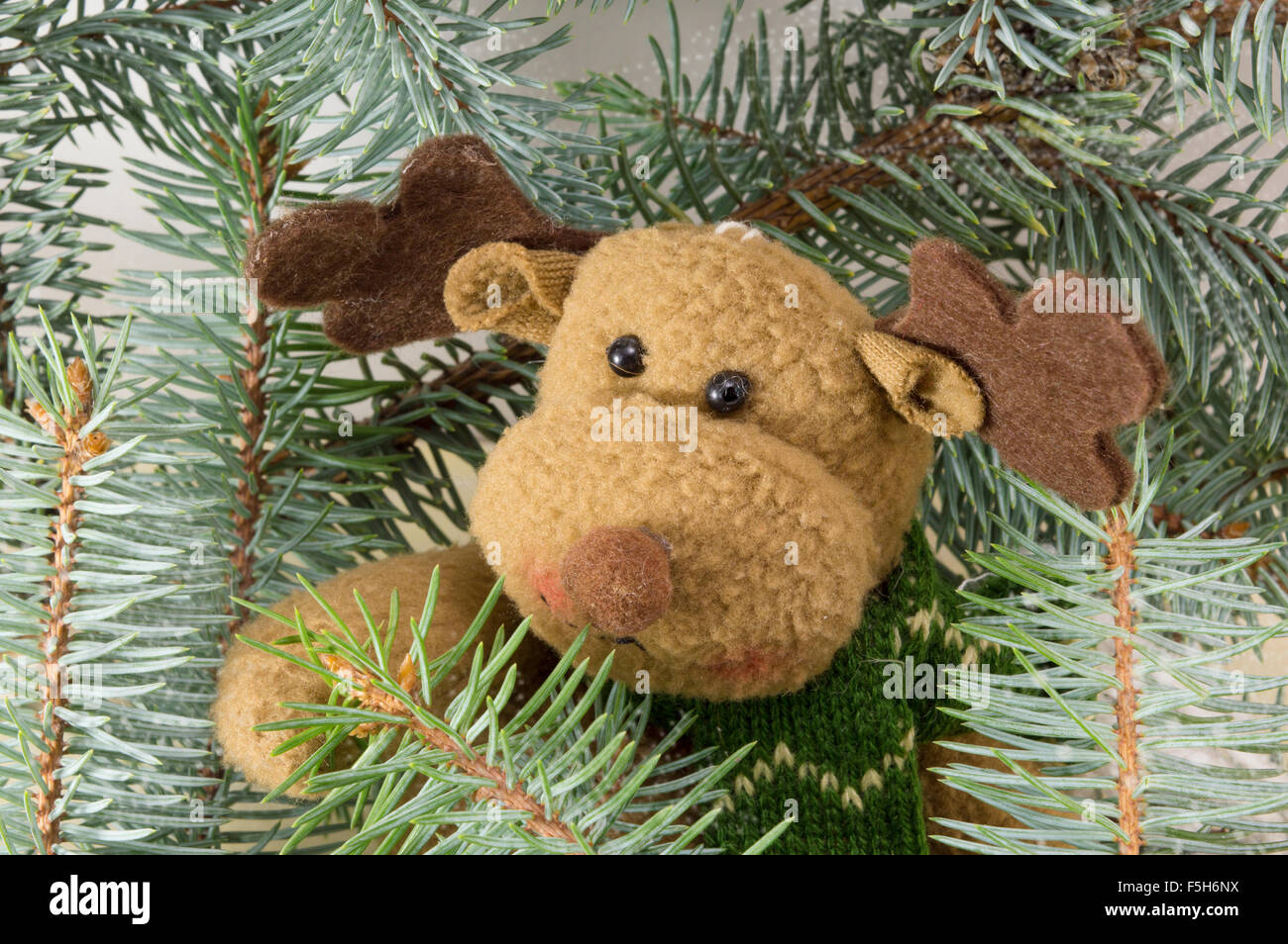 Reindeer with a scarf and Christmas tree branches. Christmas abstract ...