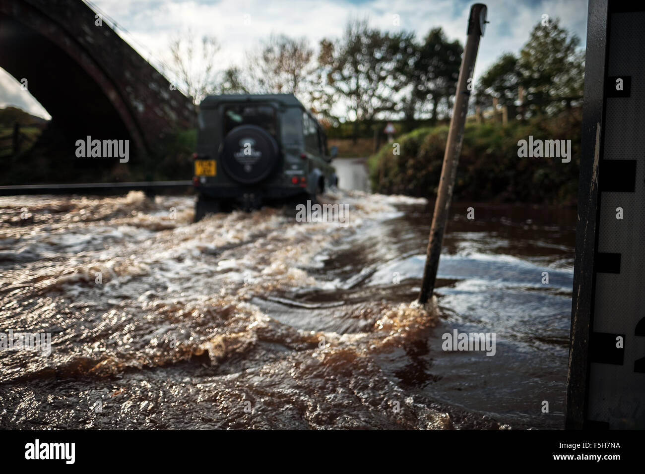 A Land Rover drives through a ford as a stream crosses a road Stock ...