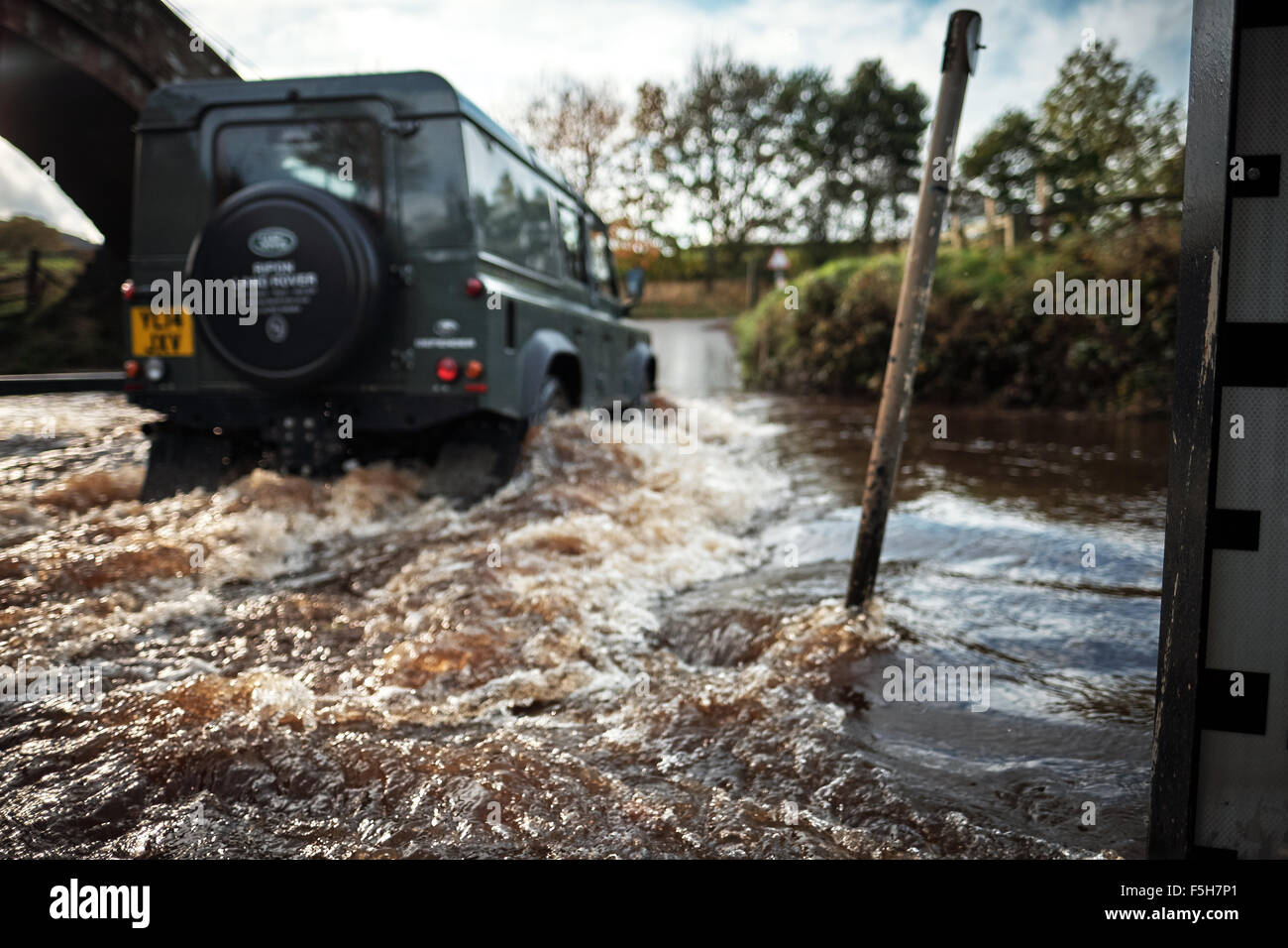 A Land Rover drives through a ford as a stream crosses a road Stock ...