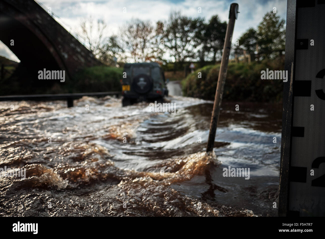 A Land Rover drives through a ford as a stream crosses a road Stock ...