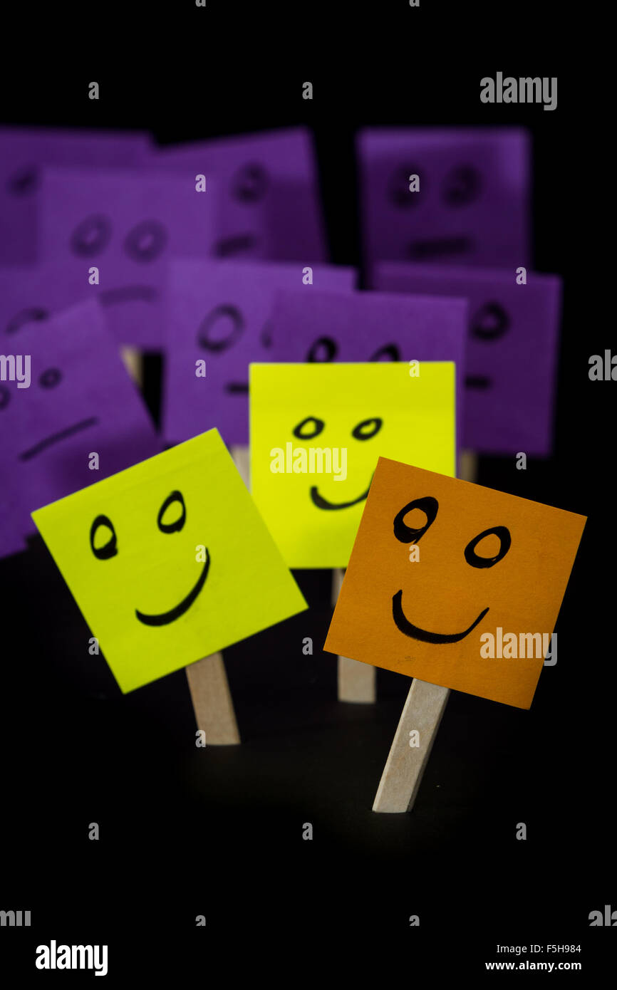 conceptual image using sticky notes with hand drawn faces on them ...