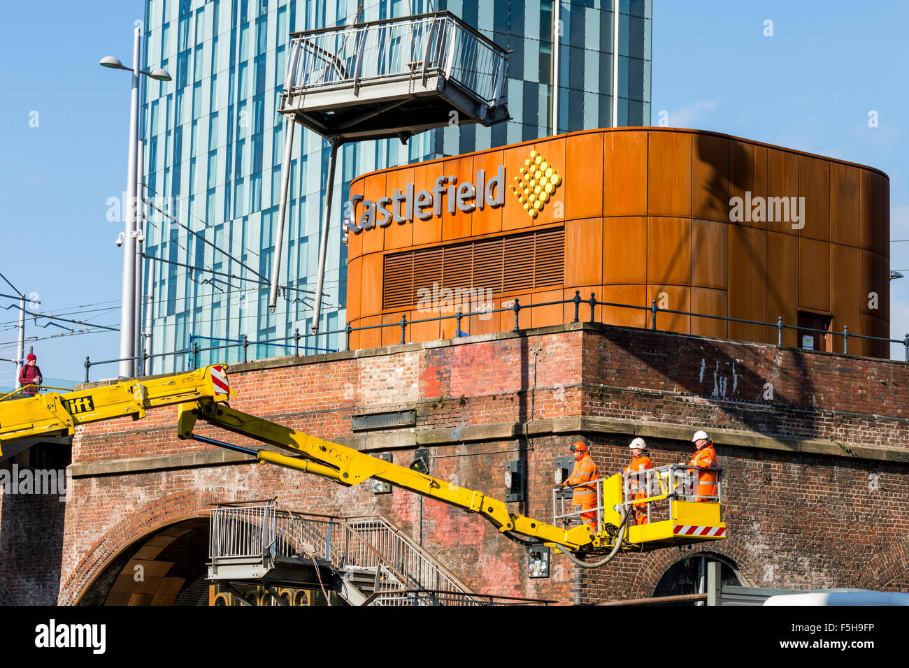 Workman on an access platform dismantling an old staircase at the ...