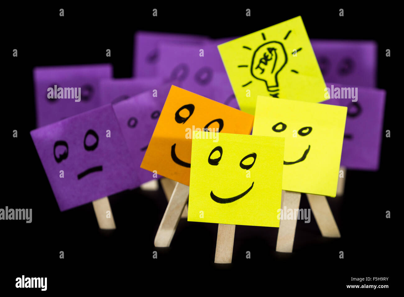 conceptual image using sticky notes with hand drawn faces on them ...