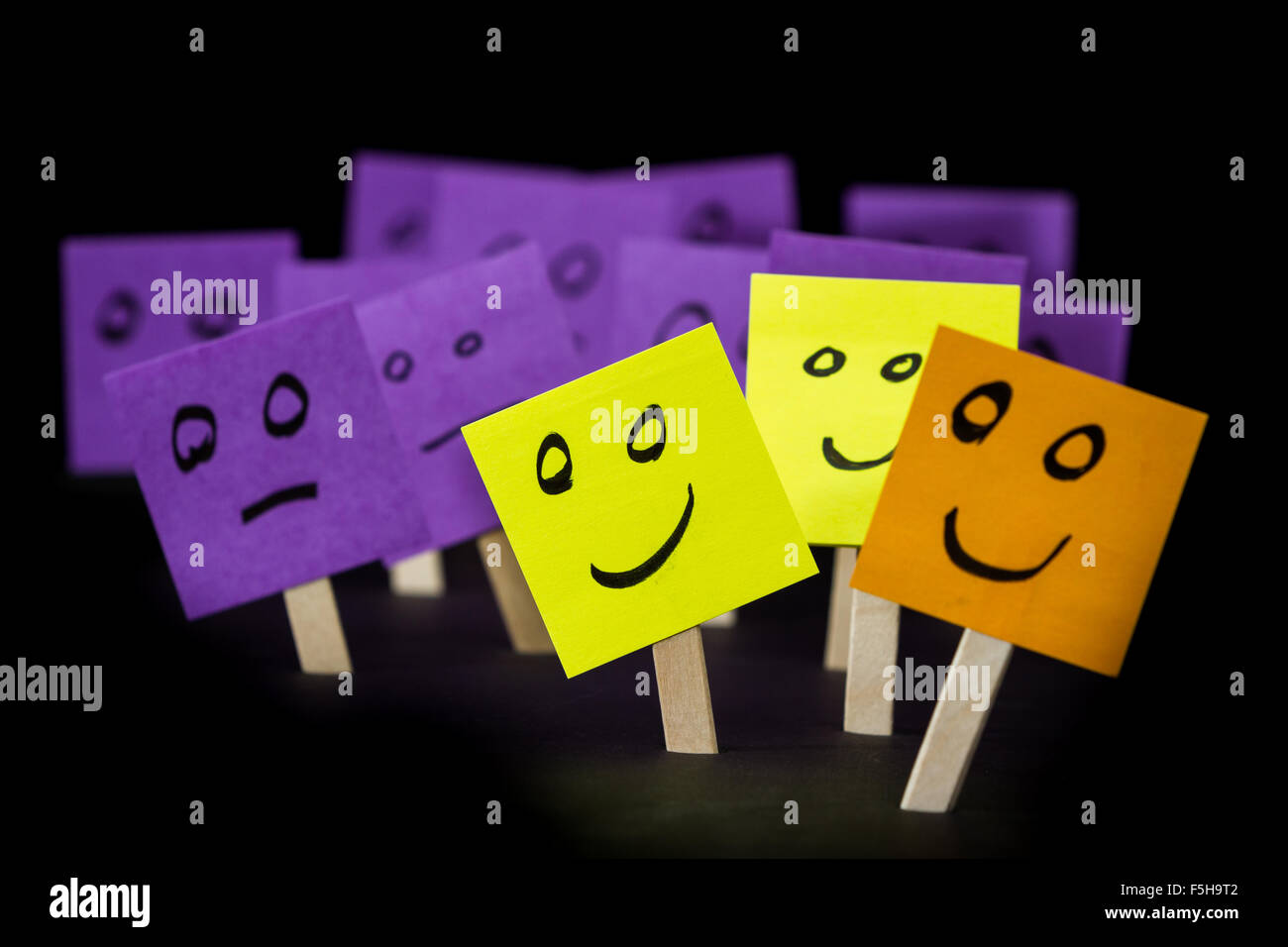conceptual image using sticky notes with hand drawn faces on them ...