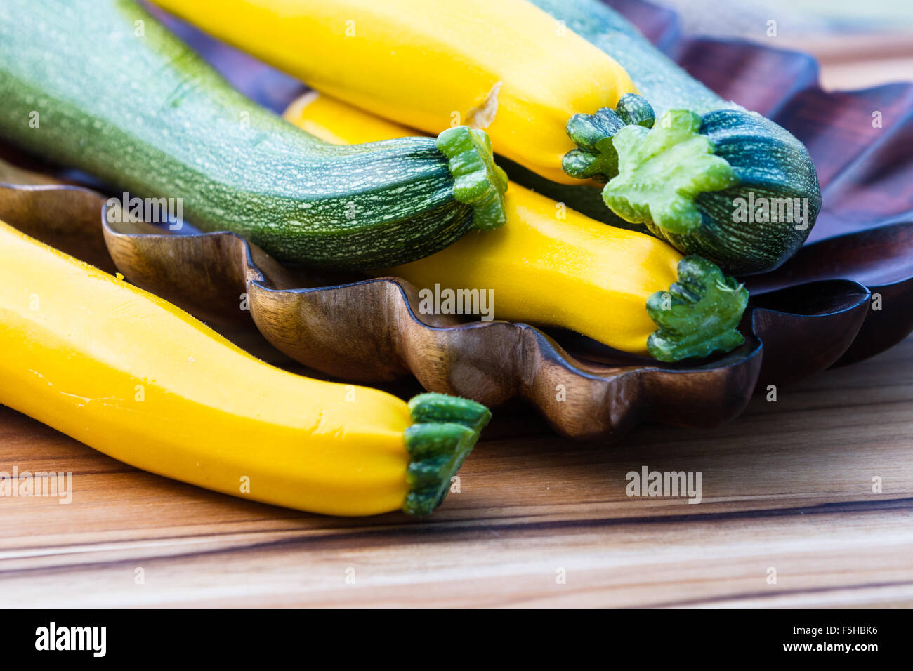 close up of a bunch of freshly picked organic green and yellow zucchini ...