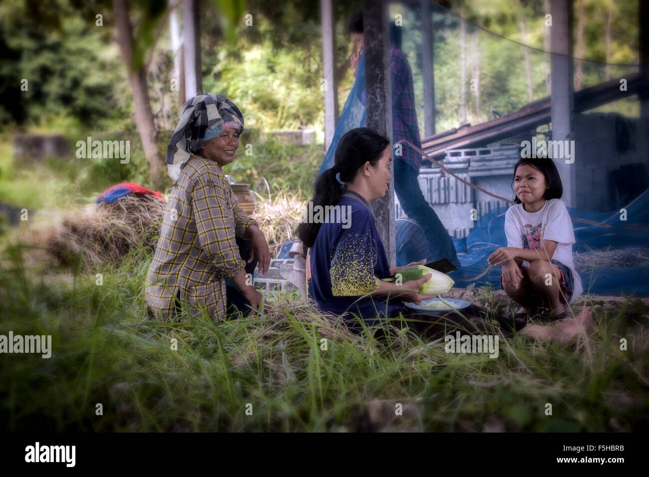 Thailand rural family with three generations of females preparing food ...