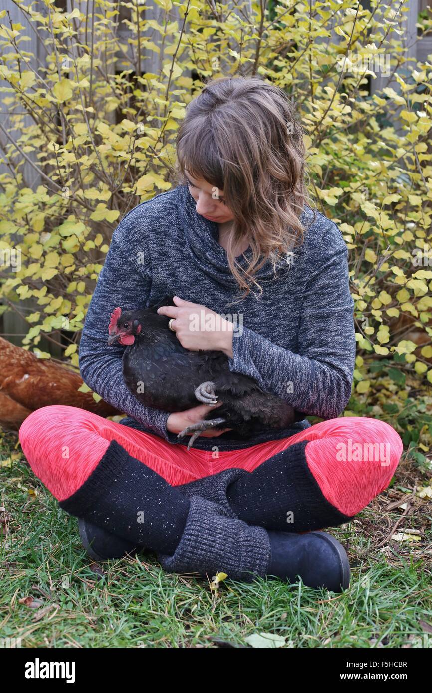 Woman holding chicken hi-res stock photography and images - Alamy