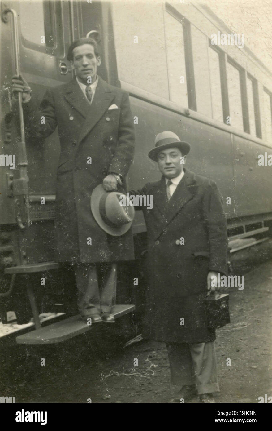 Two men leaving the train station hi-res stock photography and images ...