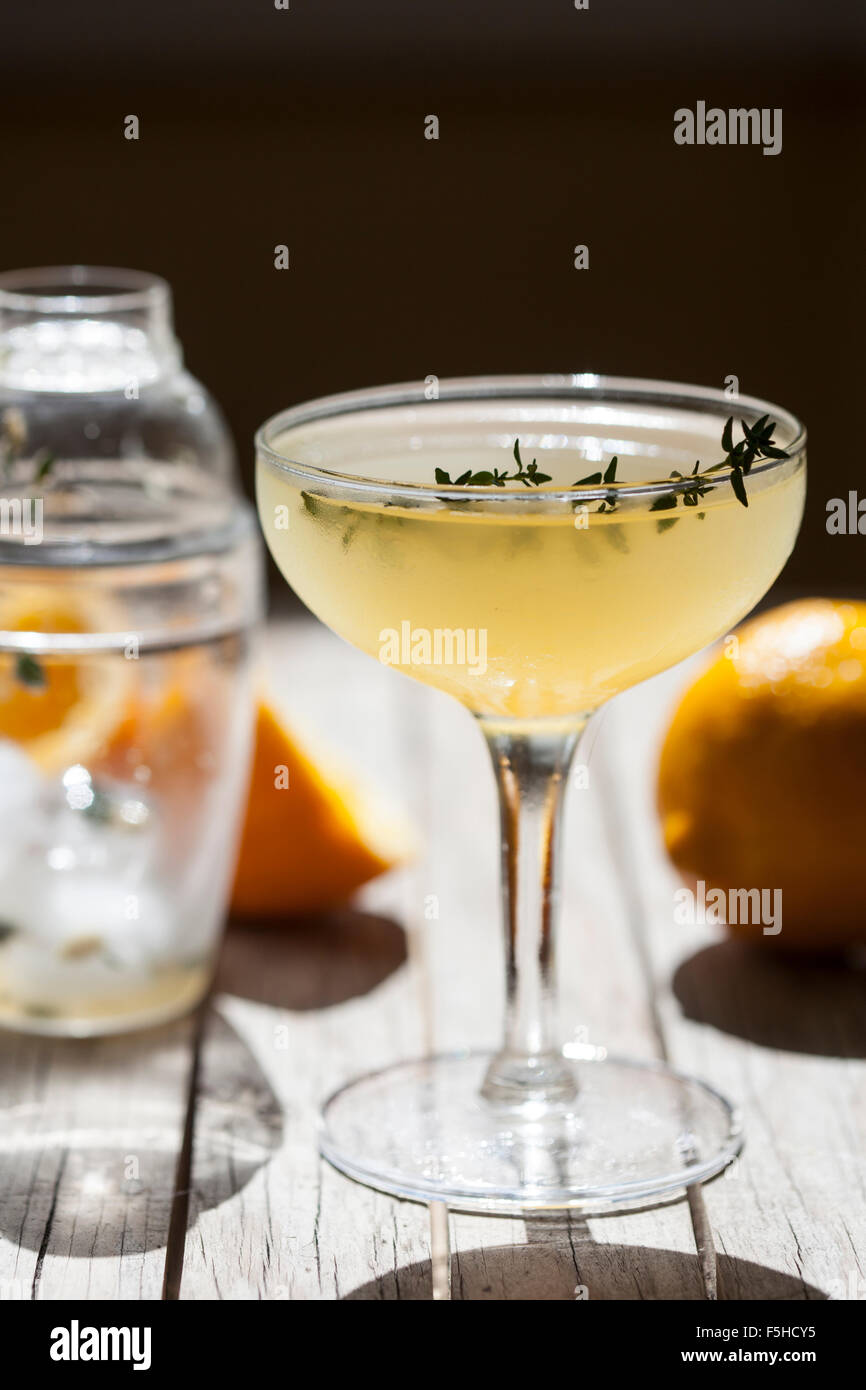 lemon cocktail in stemmed glass with lemon and cocktail shaker Stock ...