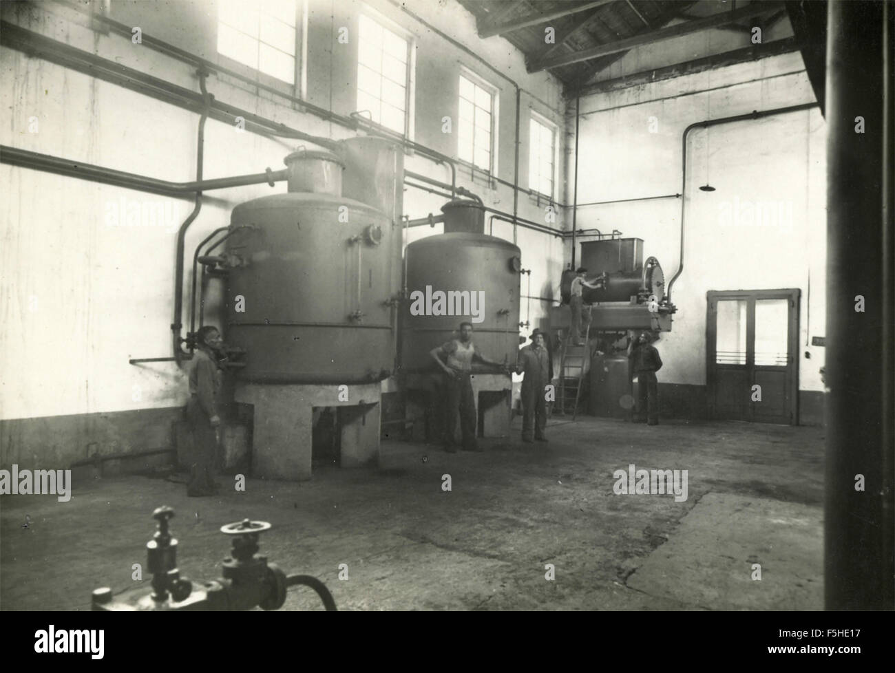 Men at work distillation oil sulfide, Italy Stock Photo - Alamy