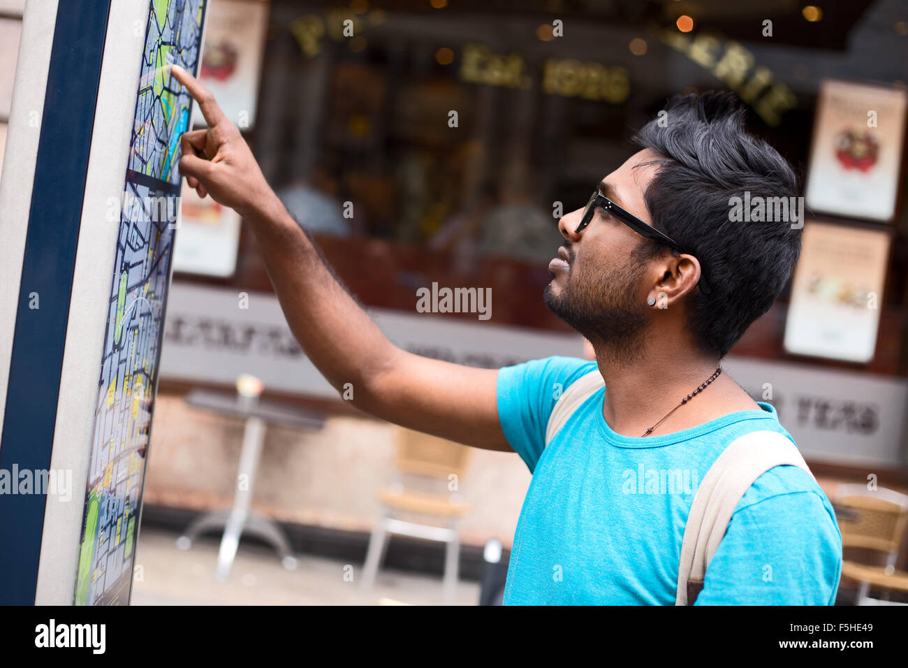 Indian man looking at sign hi-res stock photography and images - Alamy