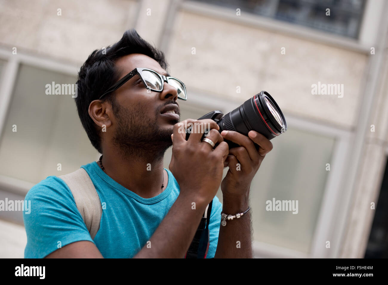 young photographer holding a camera Stock Photo - Alamy