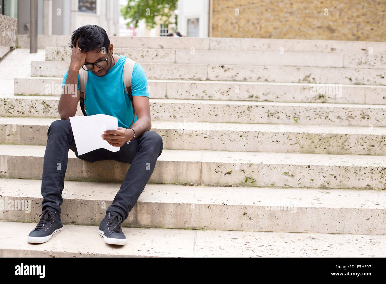 Young man reading letter hi-res stock photography and images - Alamy