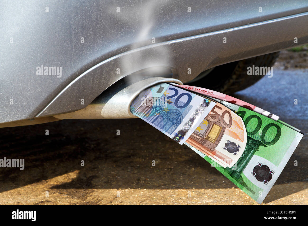 Exhaust of a car with money Stock Photo - Alamy