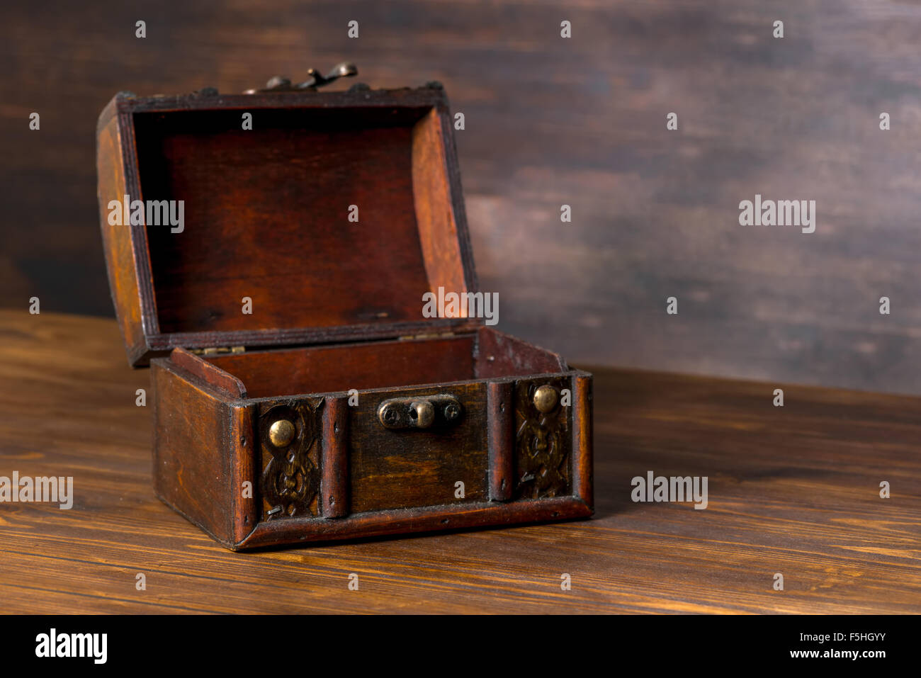 beautiful vintage chest with open lid on wooden background, closeup ...