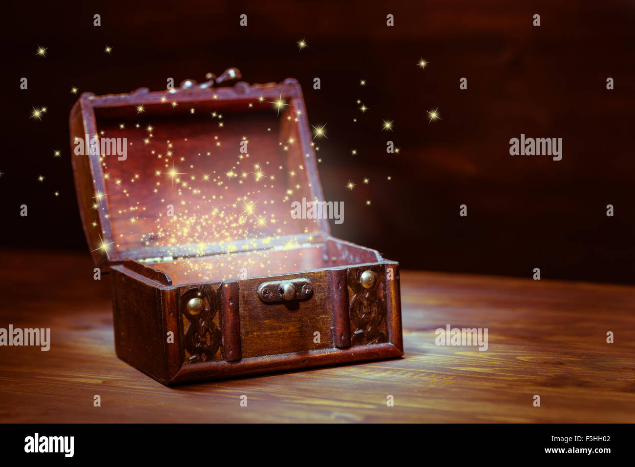 beautiful background of mystery chest with light miracle on wooden ...