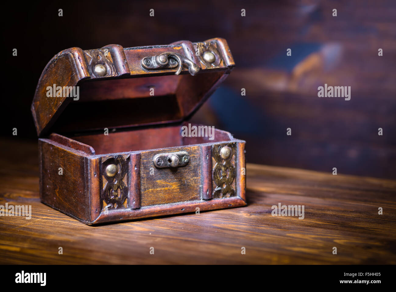 beautiful retro chest with open lid on wooden background with place for ...