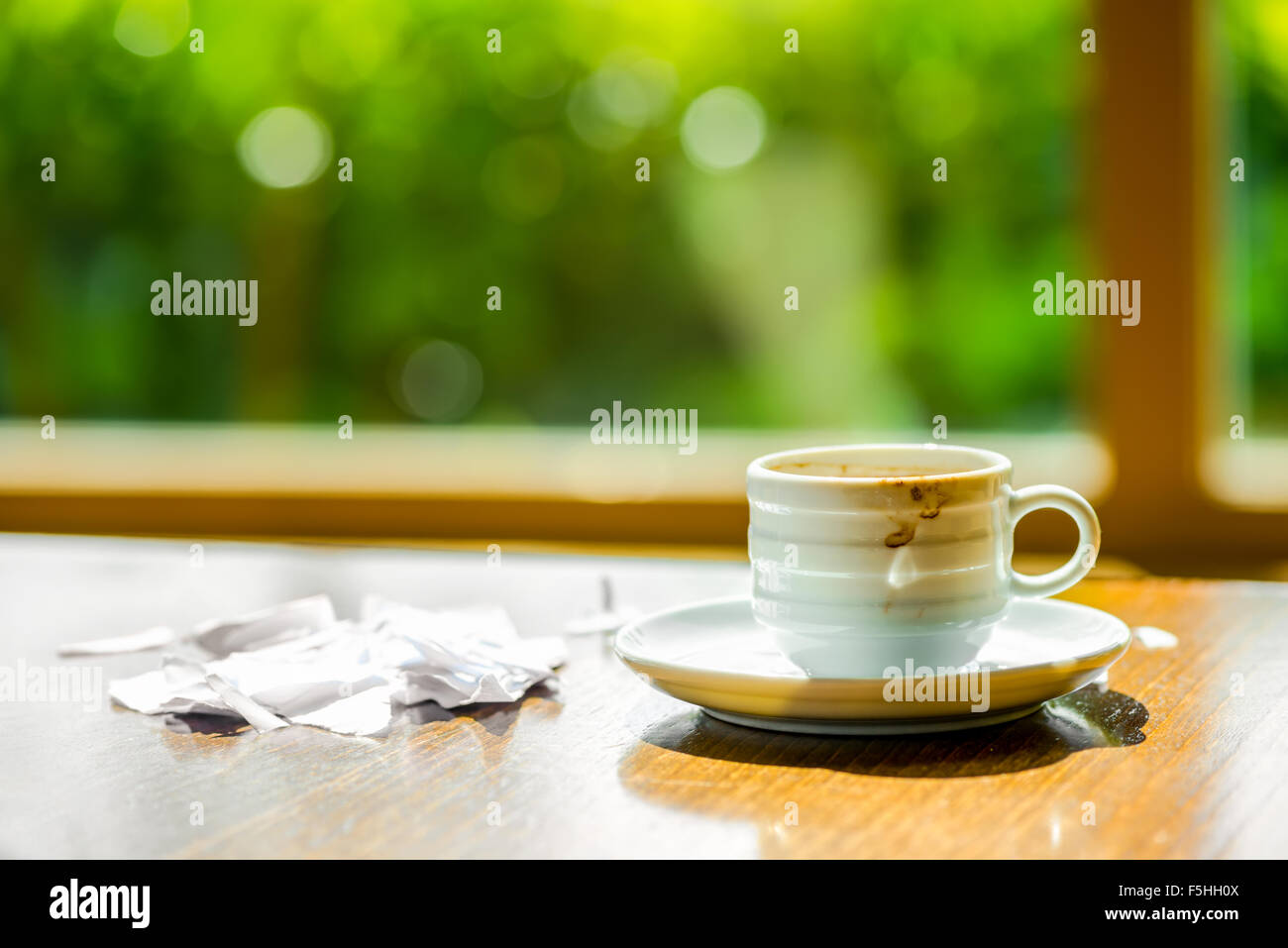 concept of cup coffee drunk and torn paper near the window in the ...